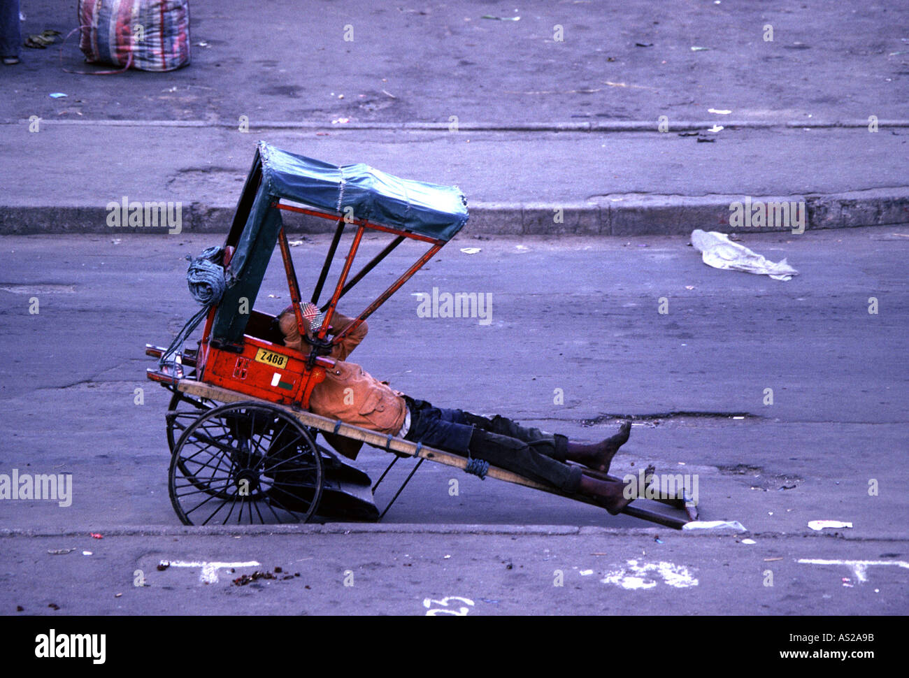 Tired pousse pousse operator taking a rest at the end of the day in ...