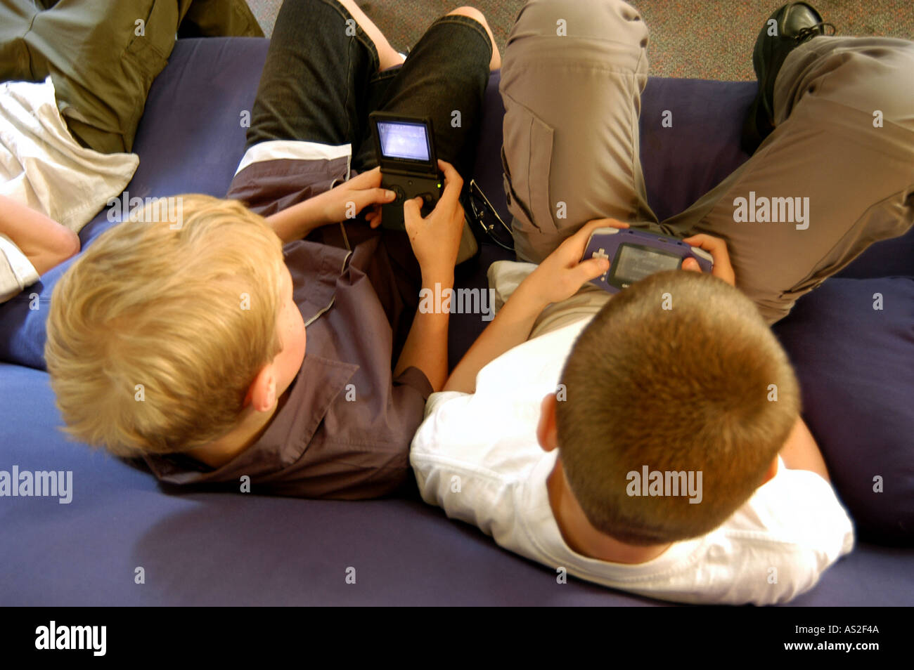 Viewed from above two boys play with game boy computers Stock Photo - Alamy