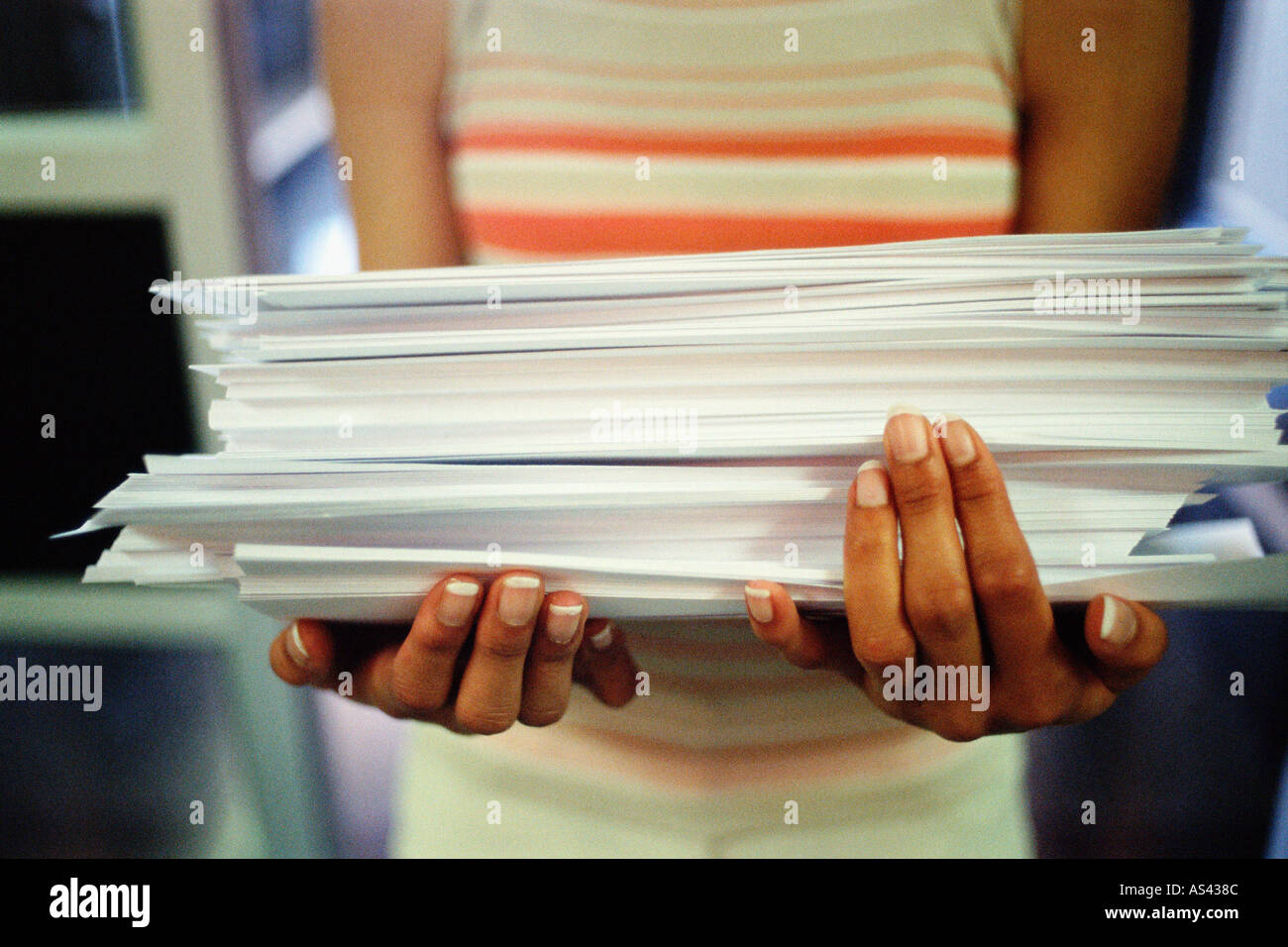 Woman carrying stack of paper Stock Photo - Alamy