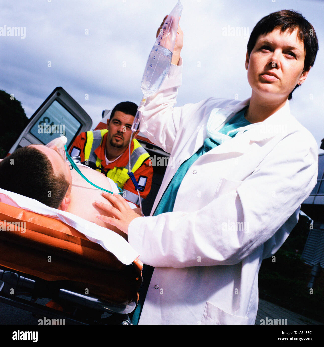 Ambulance staff with patient Stock Photo - Alamy
