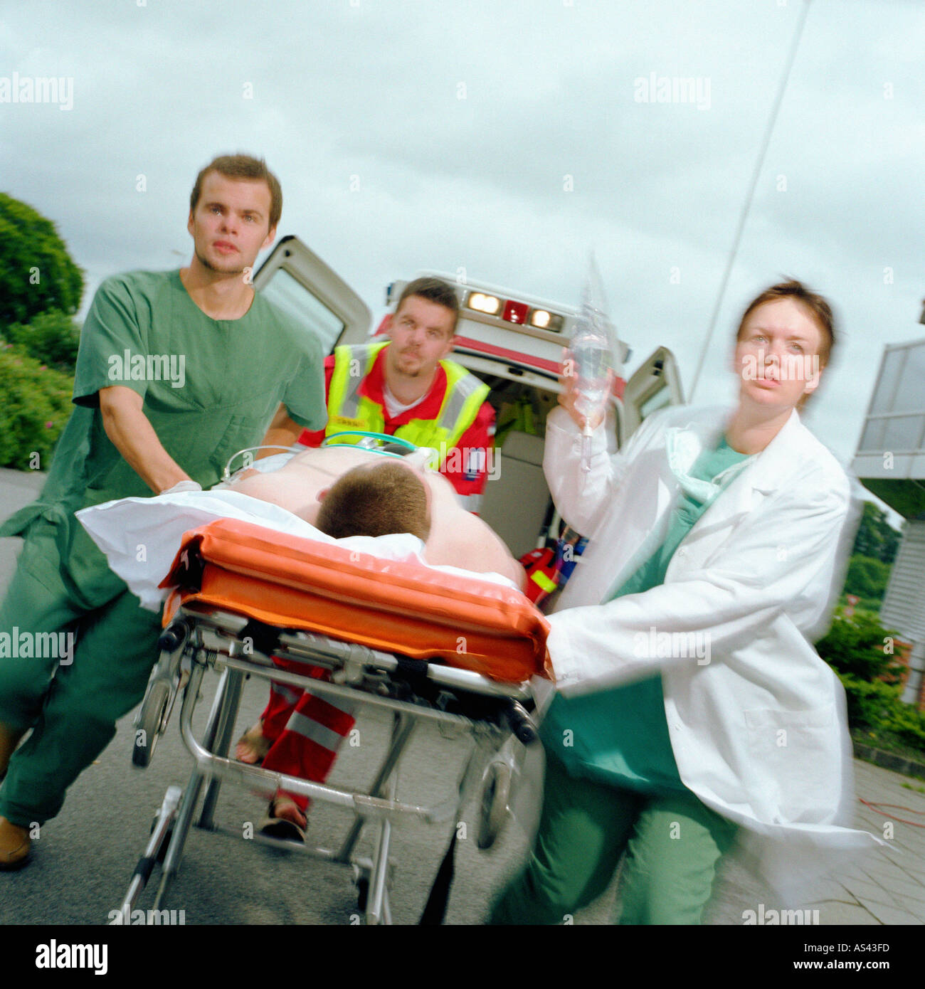 Ambulance staff with patient Stock Photo - Alamy