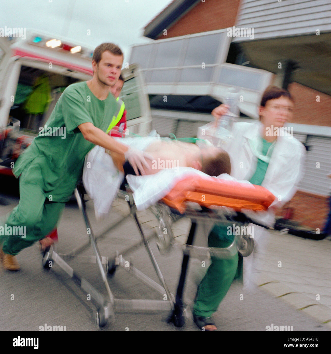 Ambulance staff with patient Stock Photo - Alamy