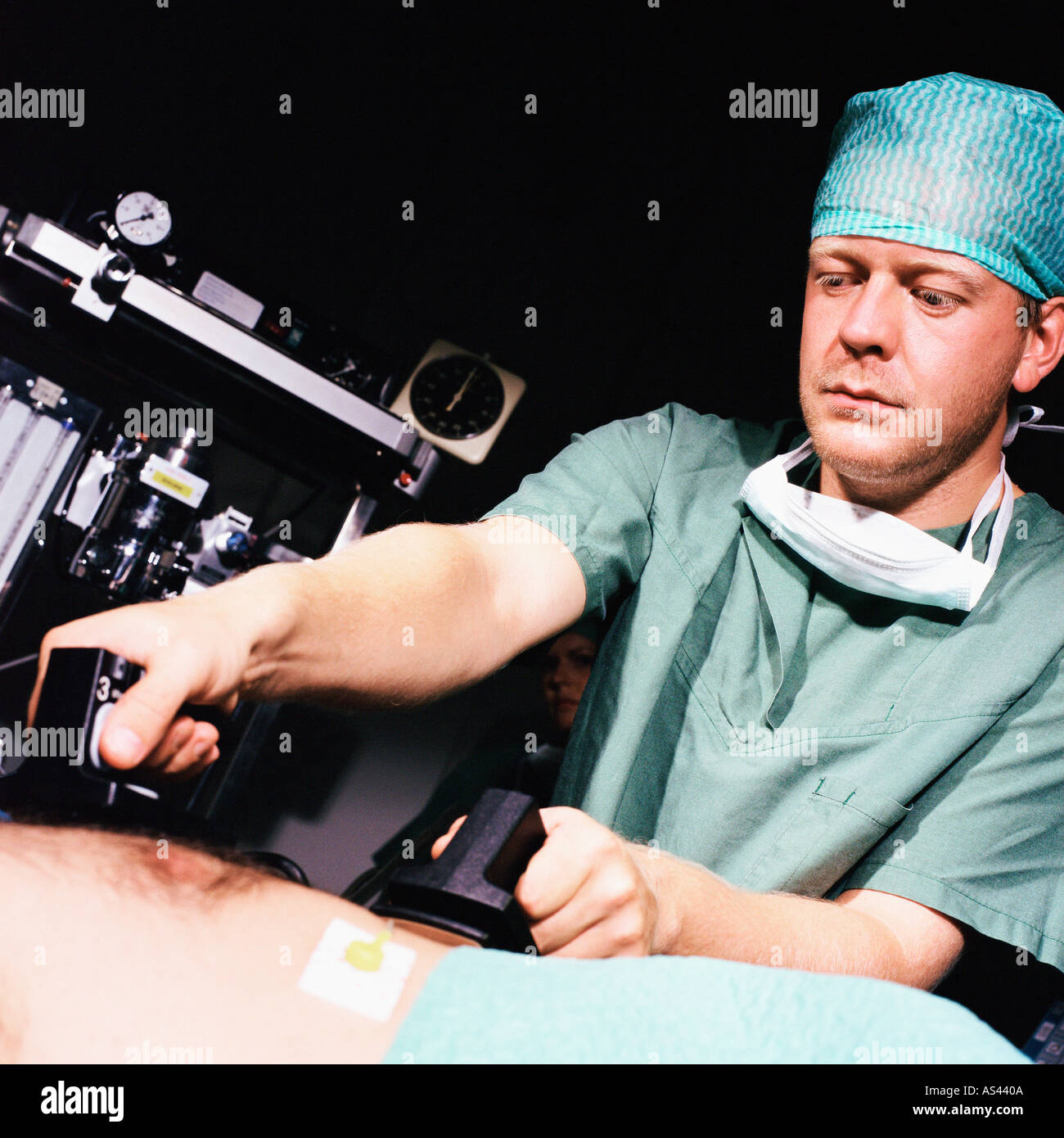 Nurse defibrillating patient Stock Photo - Alamy