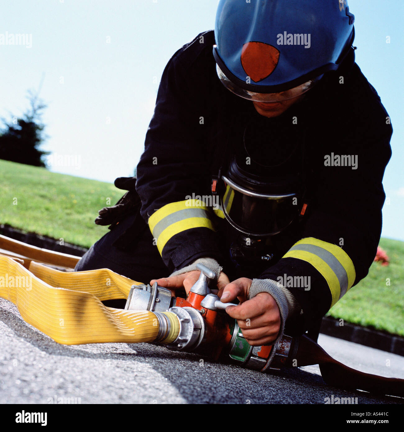 Fireman connecting hoses Stock Photo - Alamy