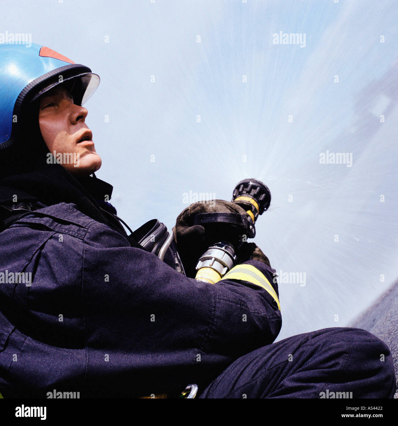 Fireman with hose hi-res stock photography and images - Alamy