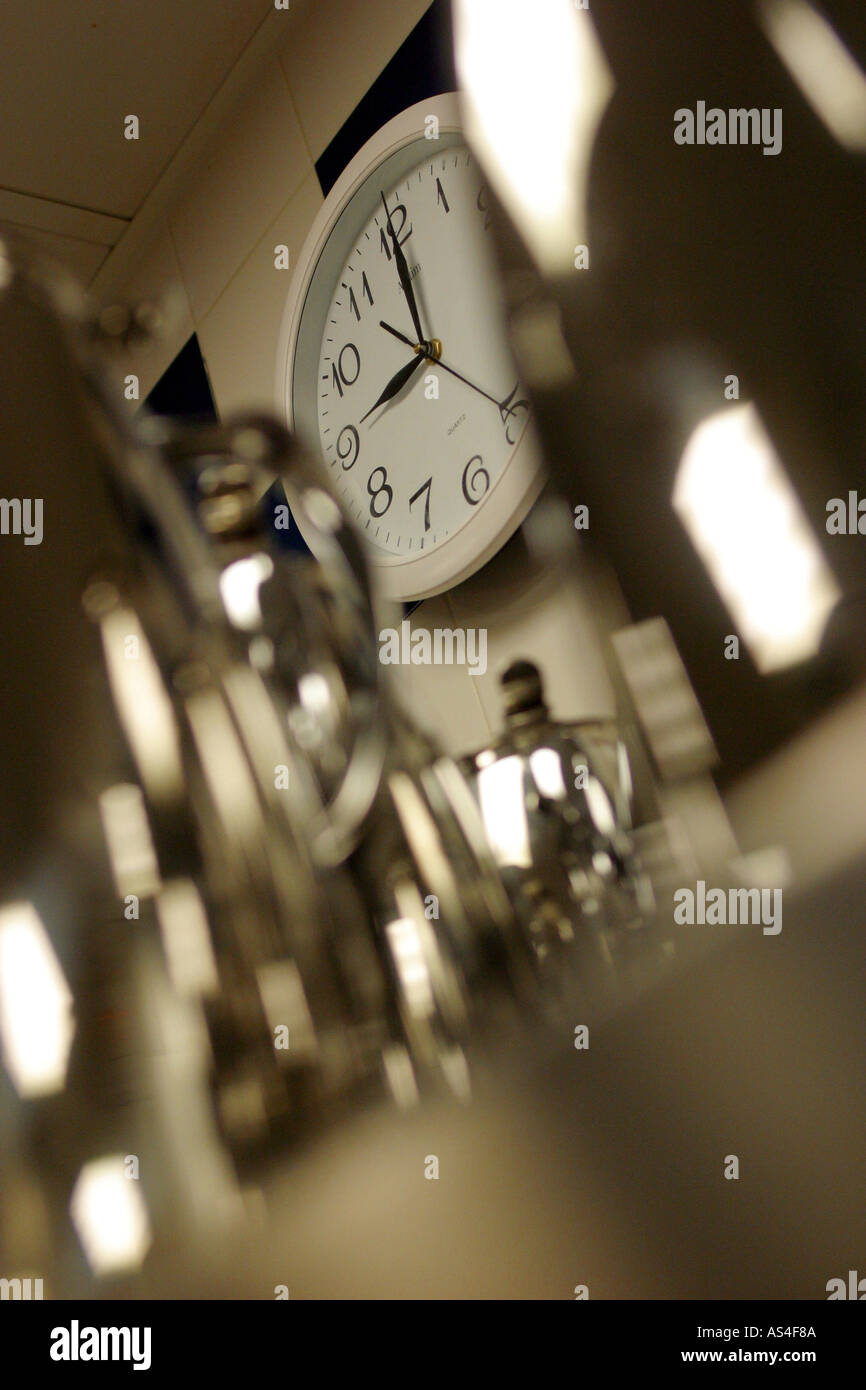 Traditional teapots in a hotel with a clock showing 9am breakfast time ...