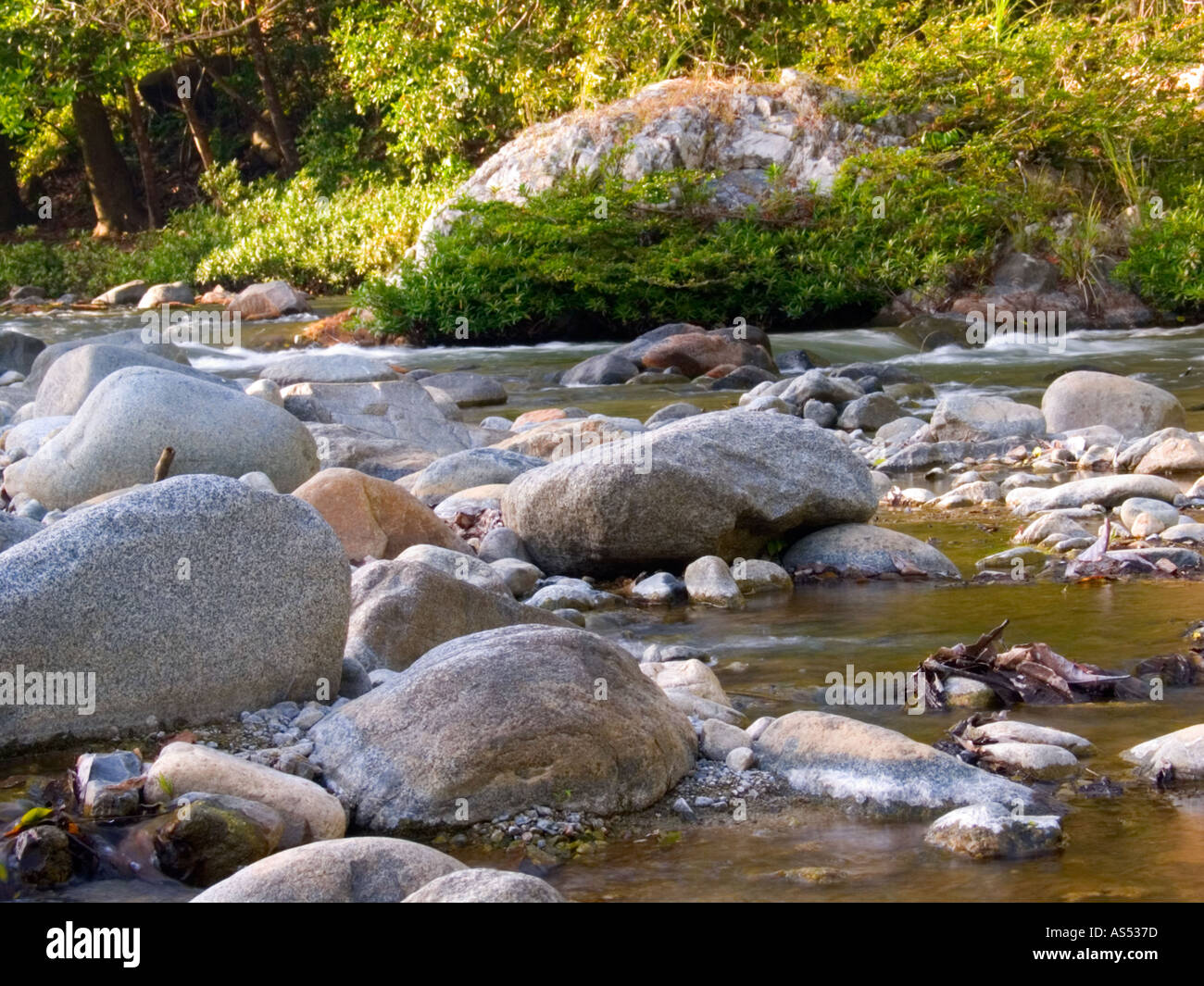 Boulder lined river Stock Photo - Alamy
