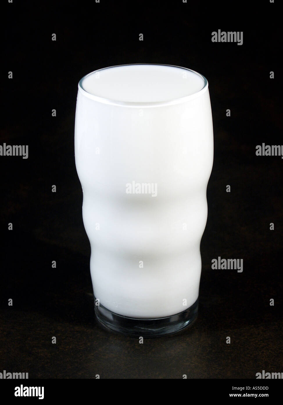 Glass of milk filled to brim Stock Photo - Alamy