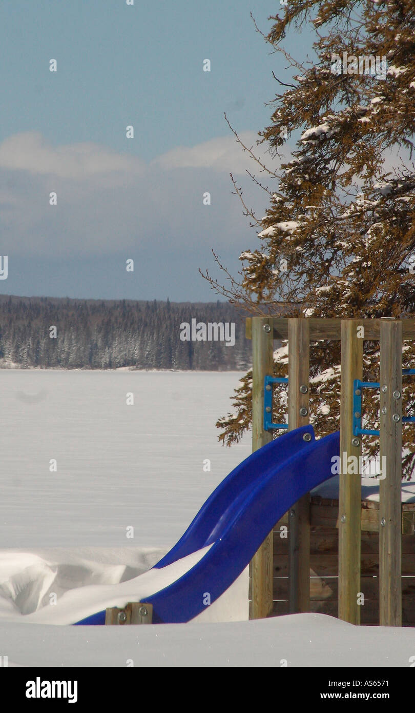 Childrens blue slide covered in snow in scenic Northern Saskatchewan ...