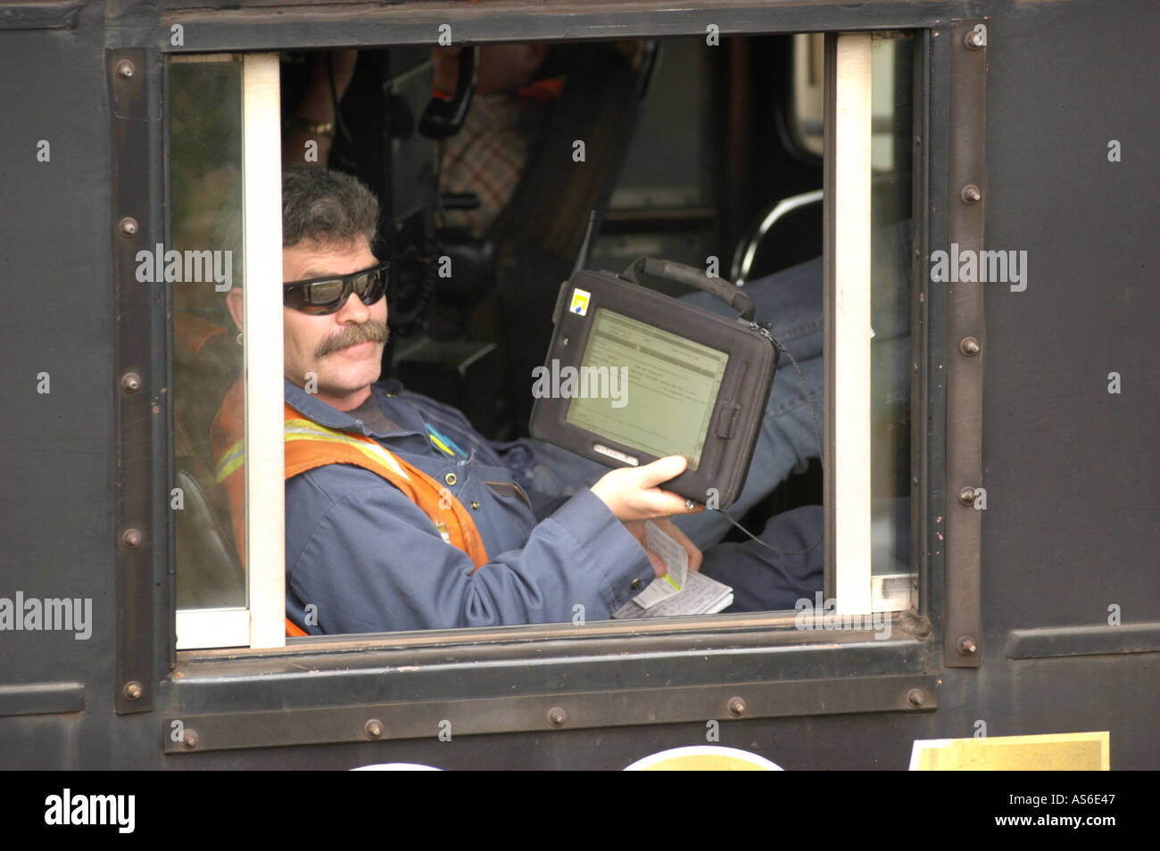 Engineer of train using handheld laptop computer for routing and ...