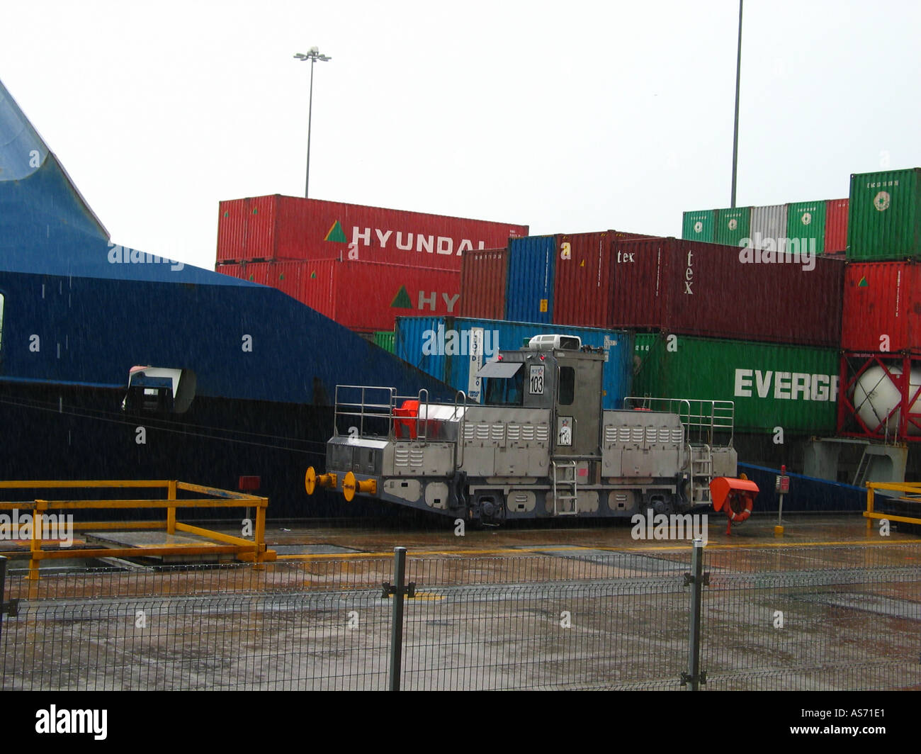 Panama Canal mule tows a cargo ship Stock Photo - Alamy