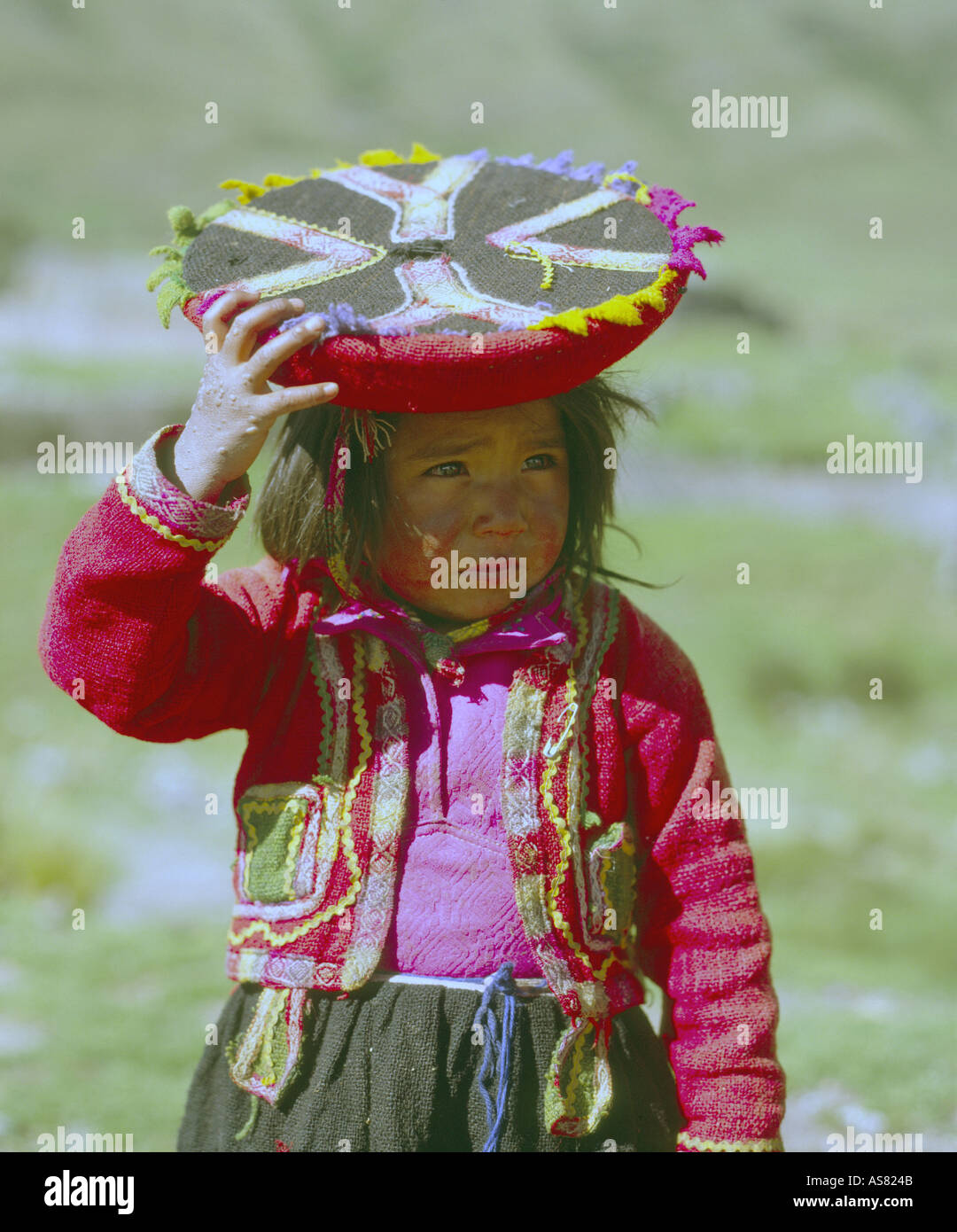 Little indian girl in traditional cuzco style dress and hat walking on ...
