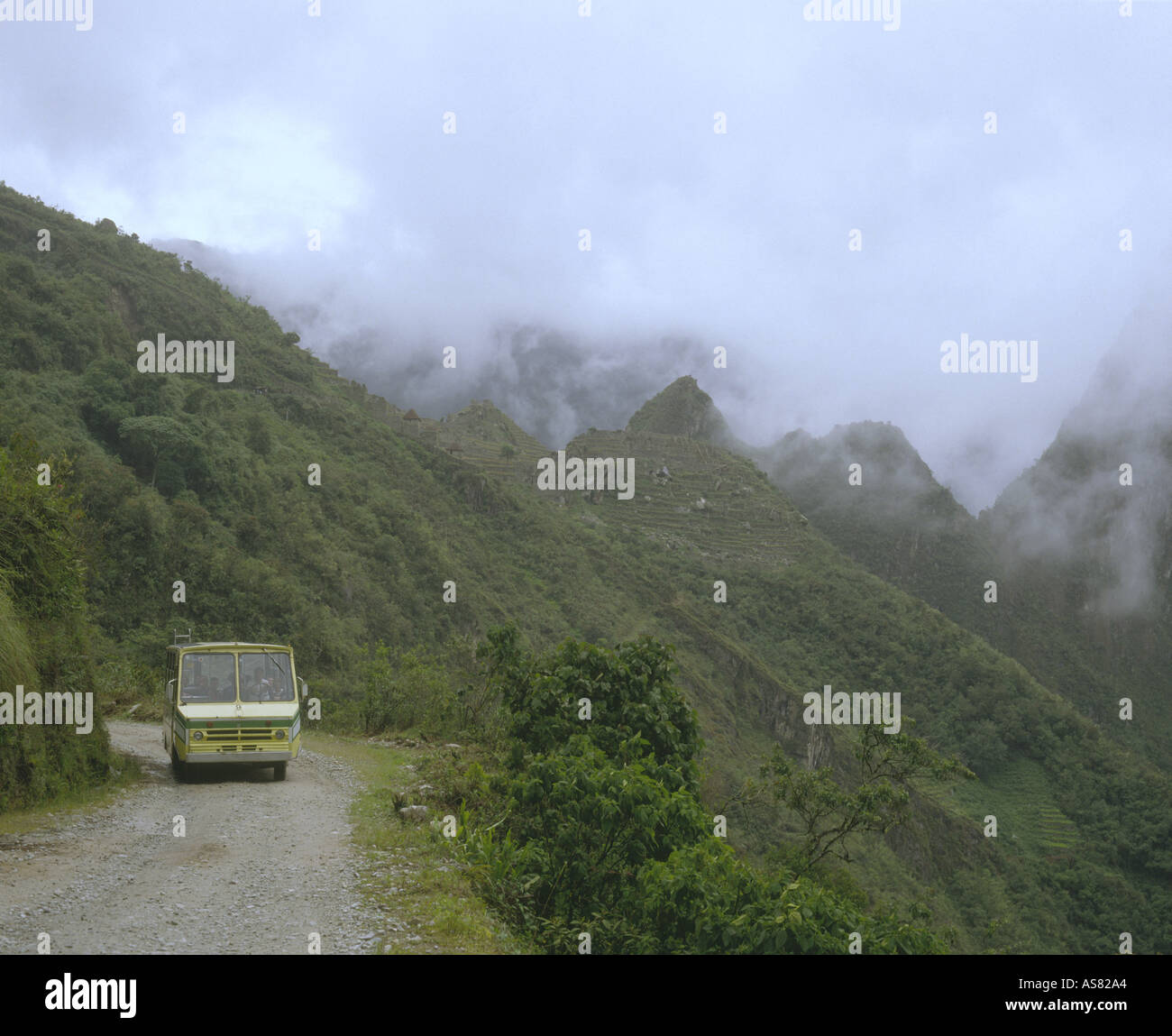 Tourist minibus wends its way along winding road up to Machu Picchu ...