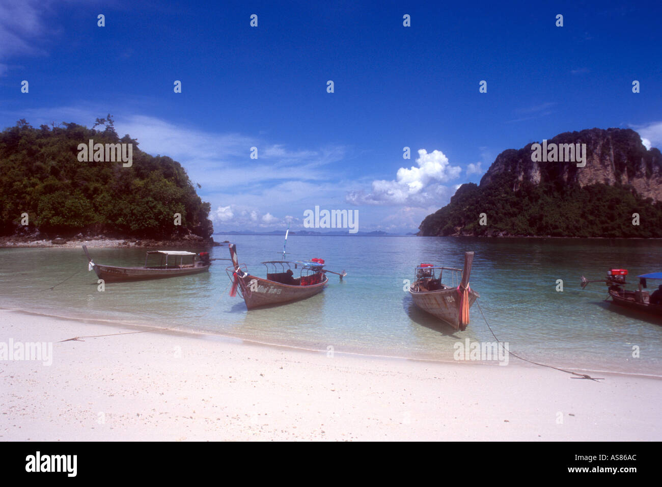 Boats songtaew off a Thai beach Krabi province Stock Photo - Alamy
