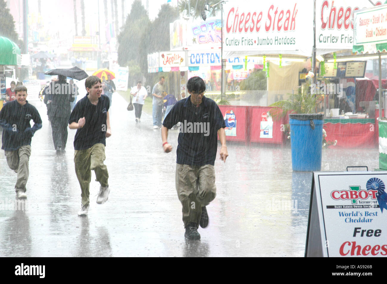 Kids running in a rain storm Florida State Fair Tampa FL Stock Photo ...