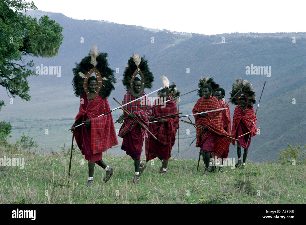 A line of Maasai warriors or morani in traditional dress on the rim of ...