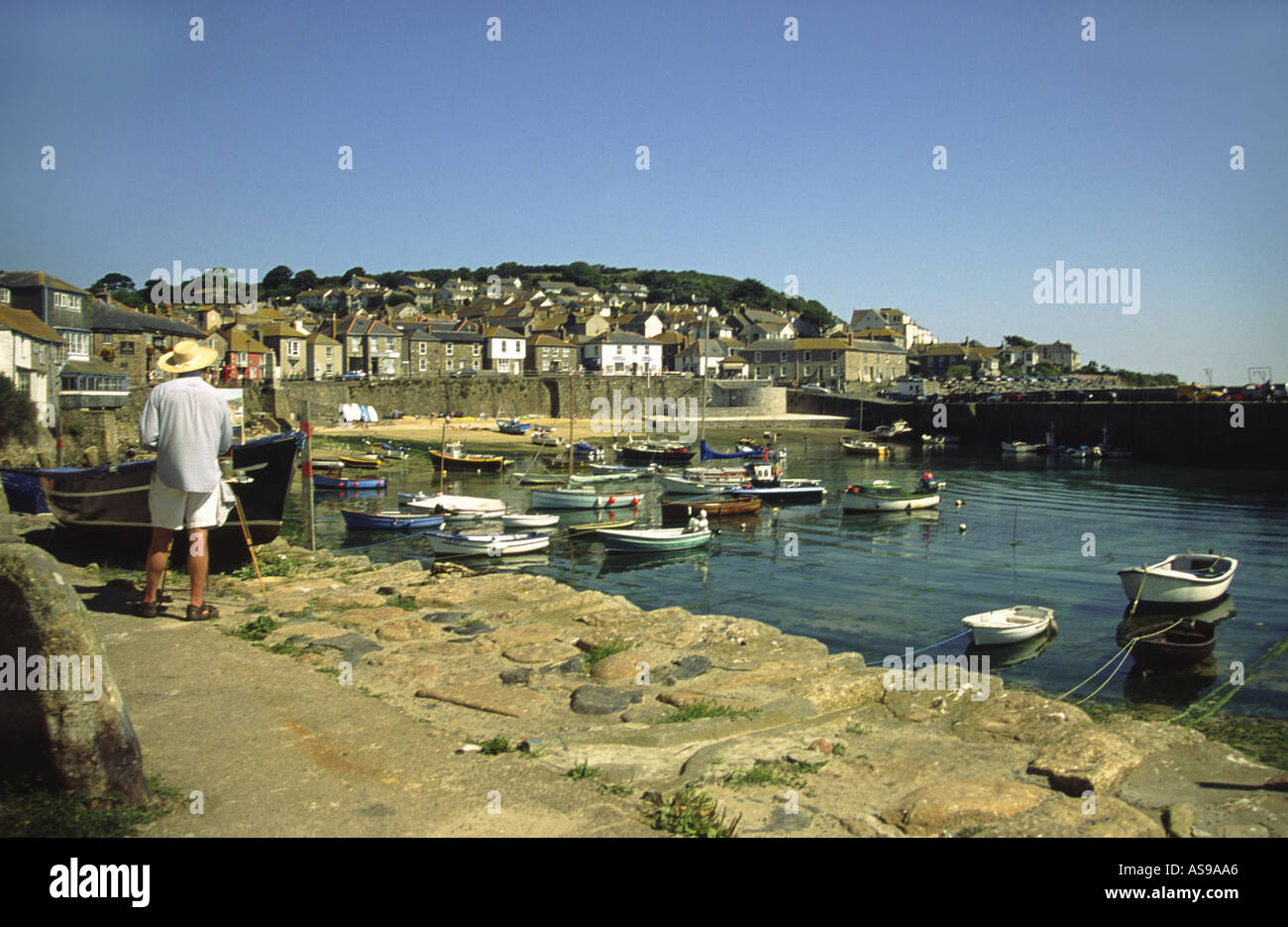 Local Artist Nigel Hallard painting at Mousehole Harbour Cornwall ...