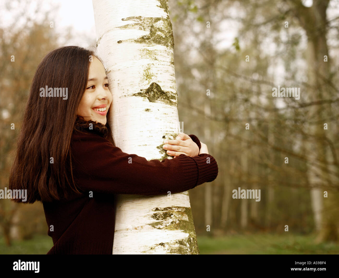 young girl hugging tree Stock Photo - Alamy