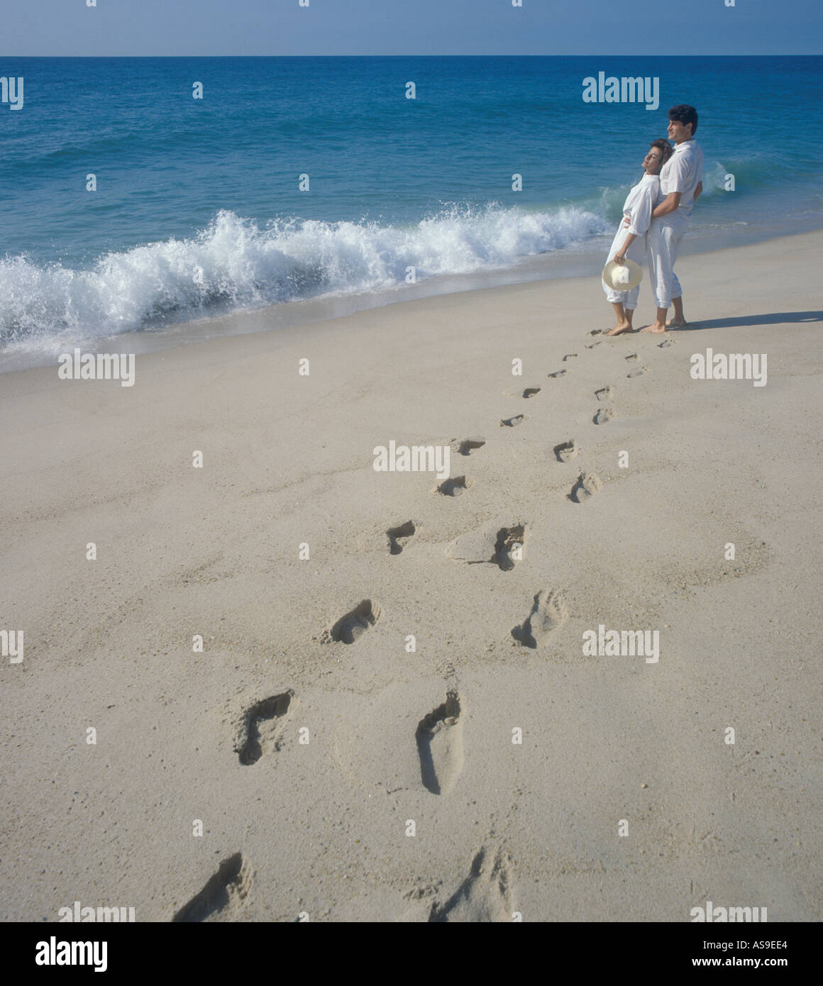 Couple leaving footprints beach hi-res stock photography and images - Alamy