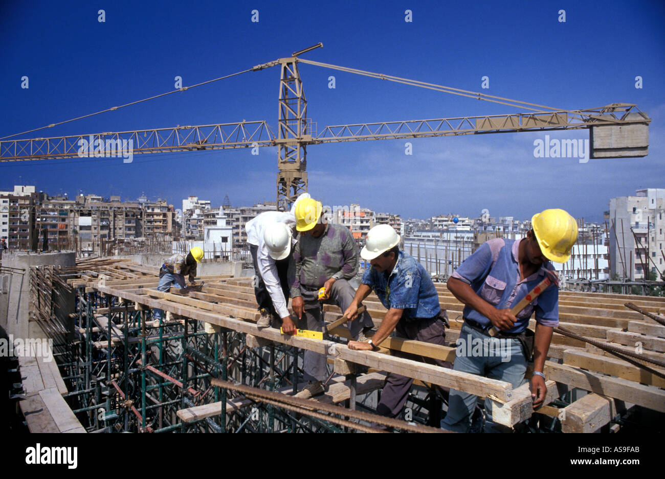 Reconstruction workers aloft new building in Beirut following end of ...