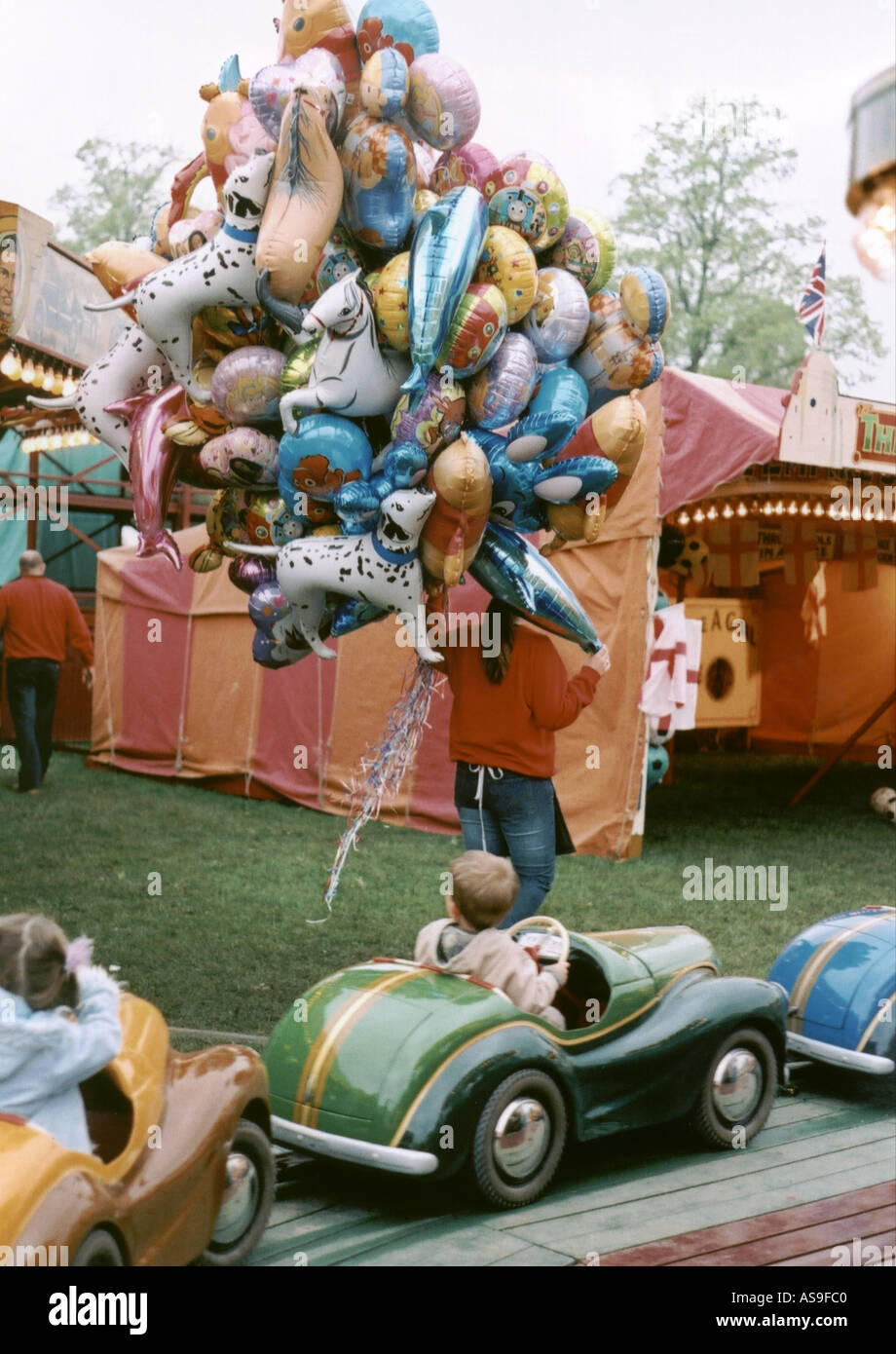 Fairground rides and balloons Stock Photo - Alamy