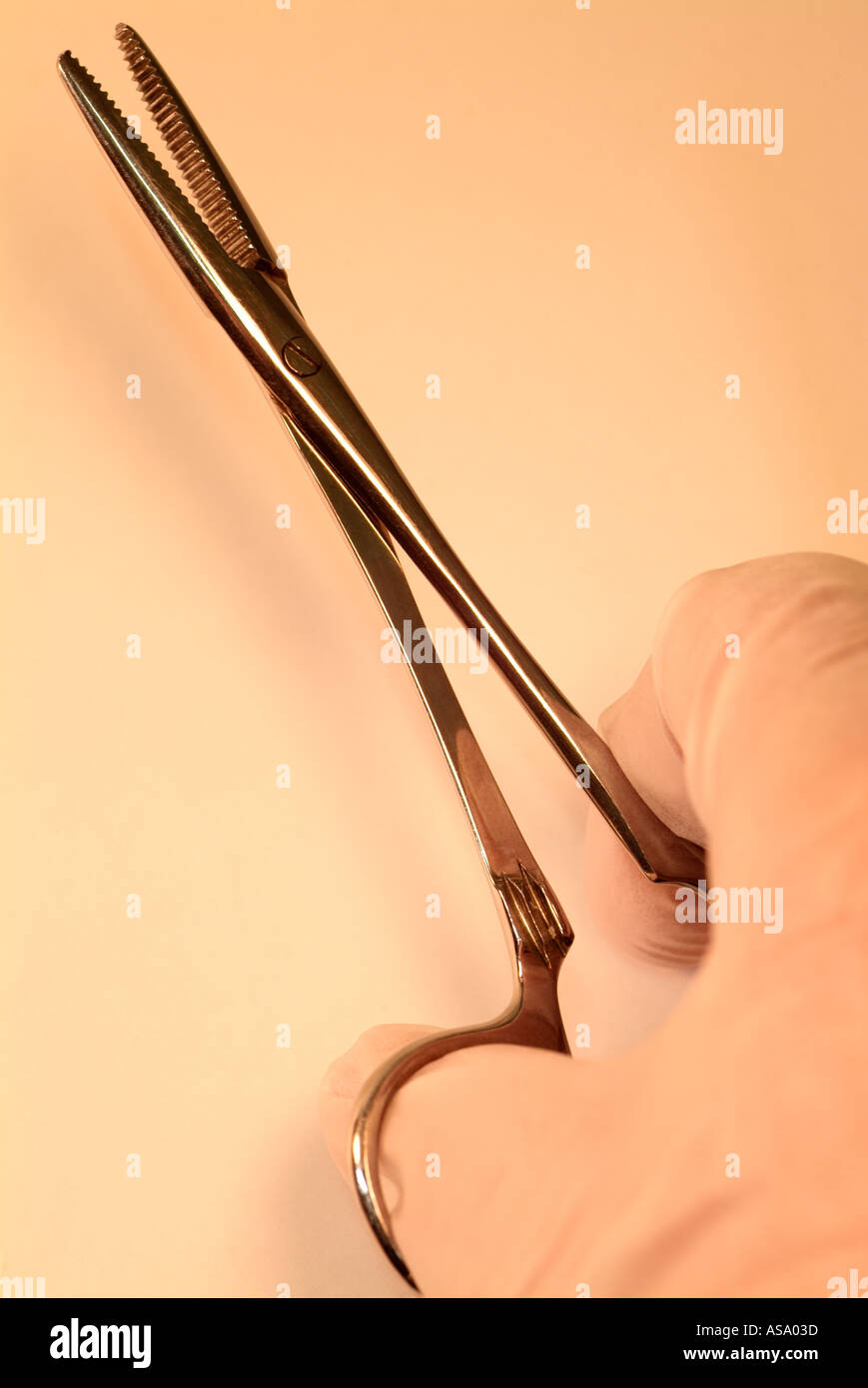 Hand Holding a Pair of Surgical Forceps Stock Photo - Alamy