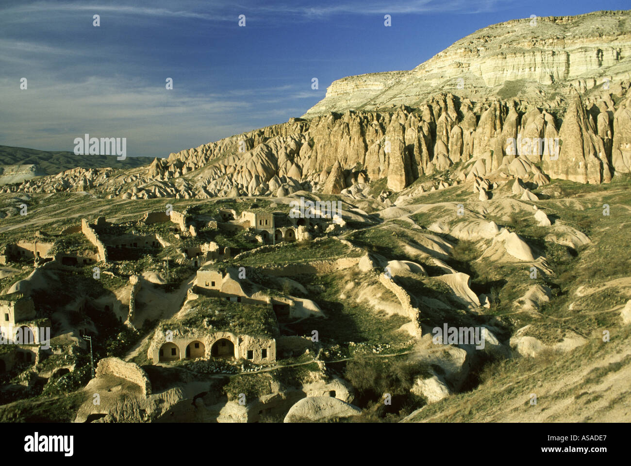 Volcanic tufa formations and village of Cavusin Cappadocia Turkey Stock ...