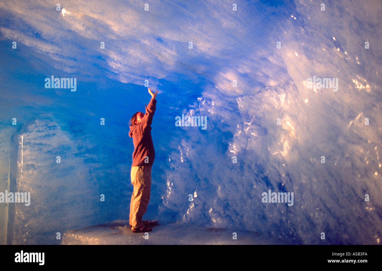 Tourist inside an ice cave in the Rhone glacier, Valais, Swiss Alps ...