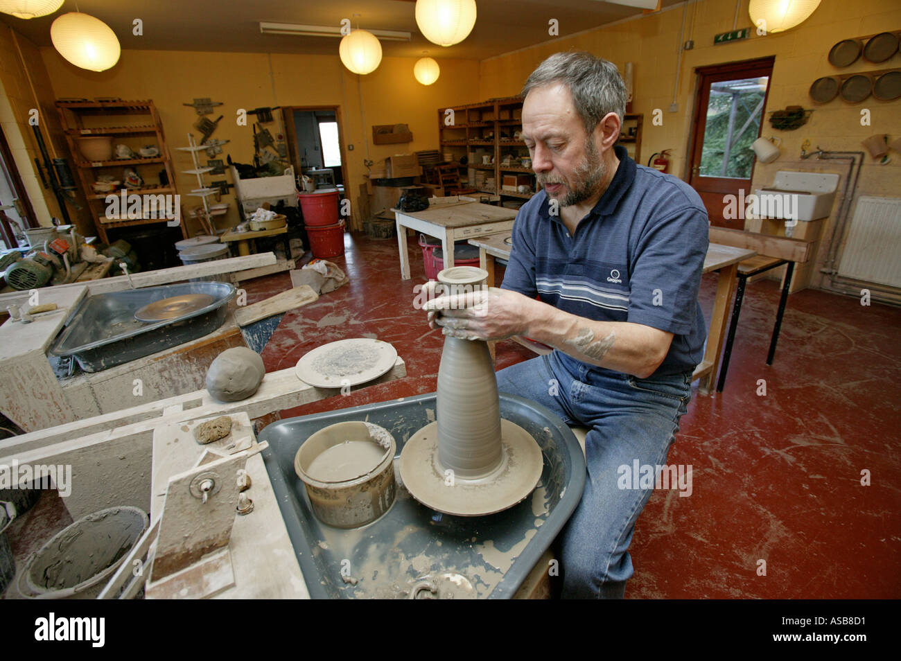 Potter working at the wheel Greystoke Gill Pottery Cumbria Stock Photo ...