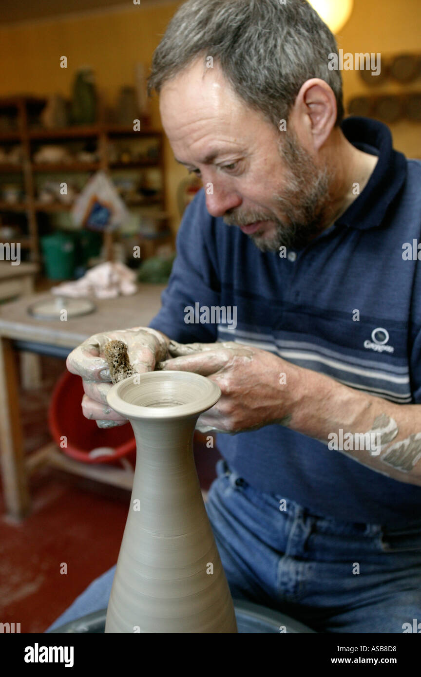 Potter working at the wheel Greystoke Gill Pottery Cumbria Stock Photo ...