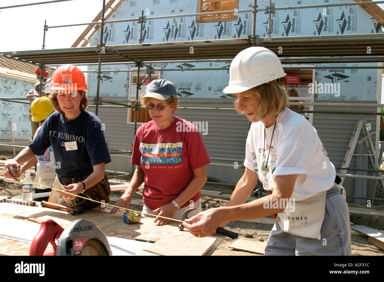Volunteers help build house for low income family through Habitat for ...