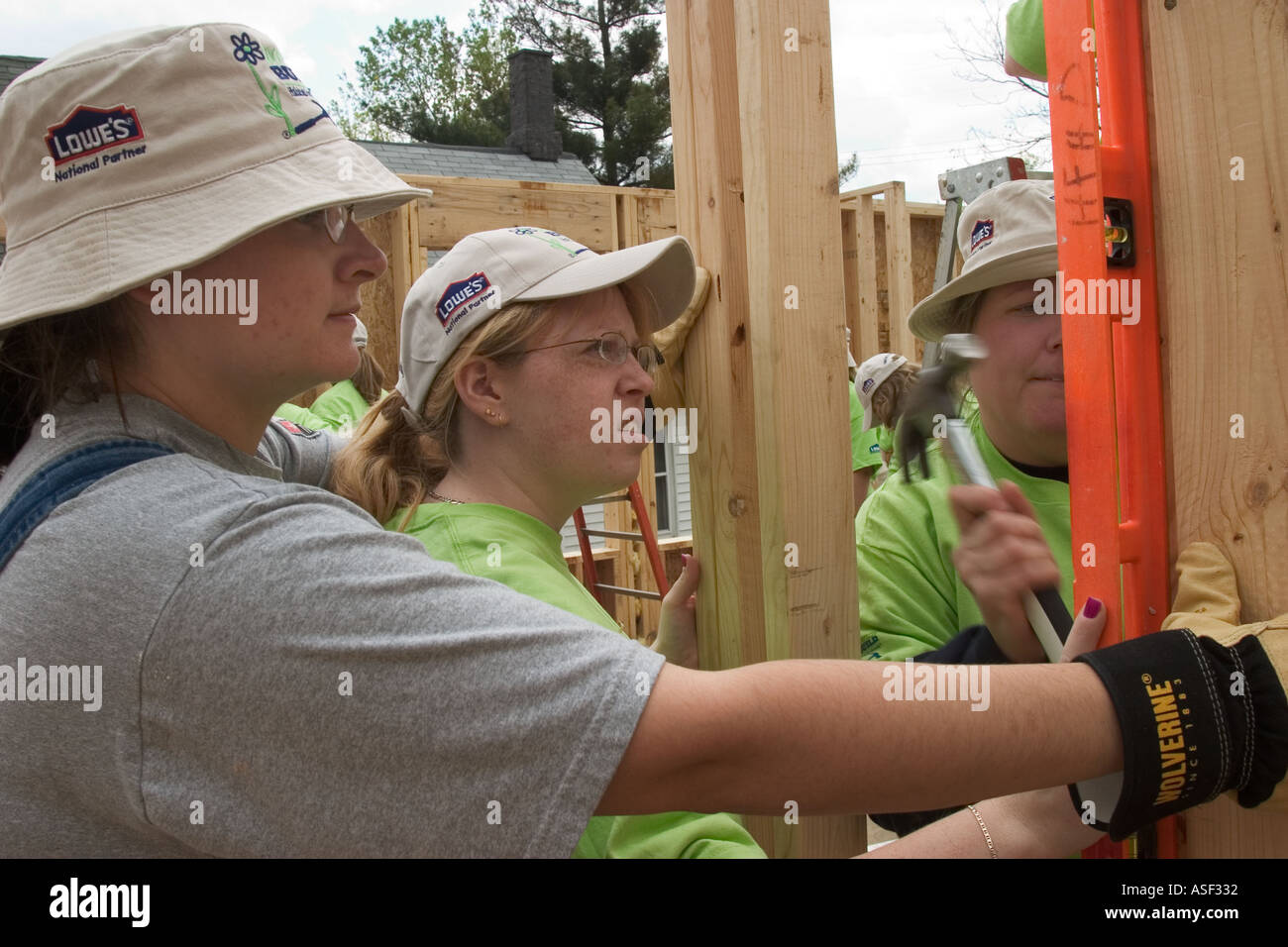 Women volunteers help build house for low income family through Habitat ...