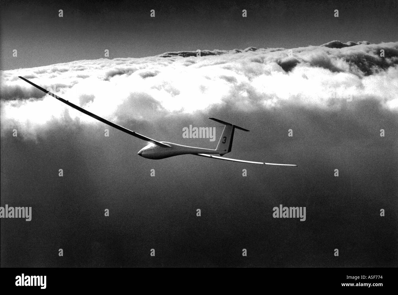 Glider soaring above the clouds Stock Photo - Alamy