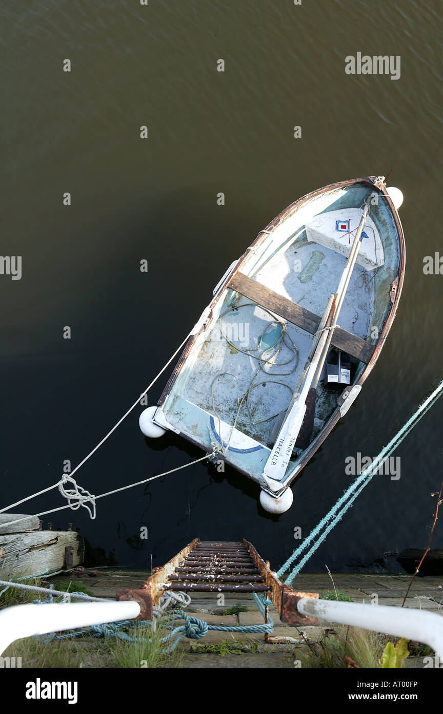 overhead view of a rowing boat moored to the harbour wall. Image ...