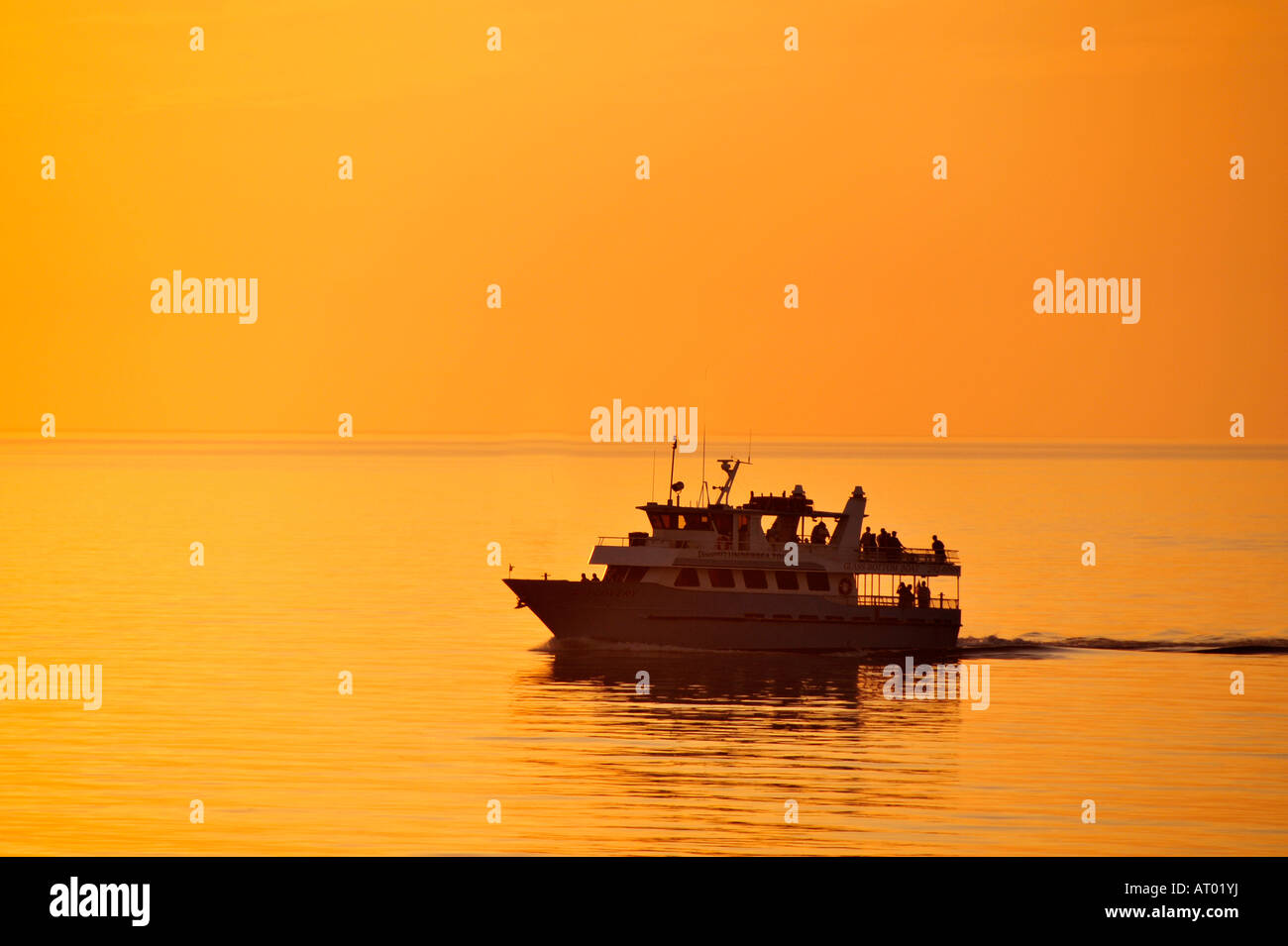 Key West Florida small cruise boat at sunset Stock Photo - Alamy