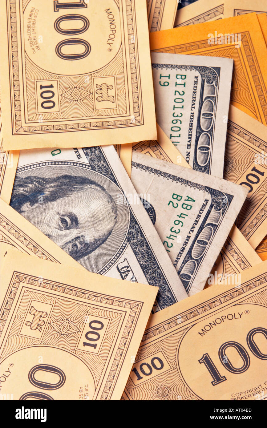 Three one hundred dollar bills mixed in with Monopoly money Stock Photo ...