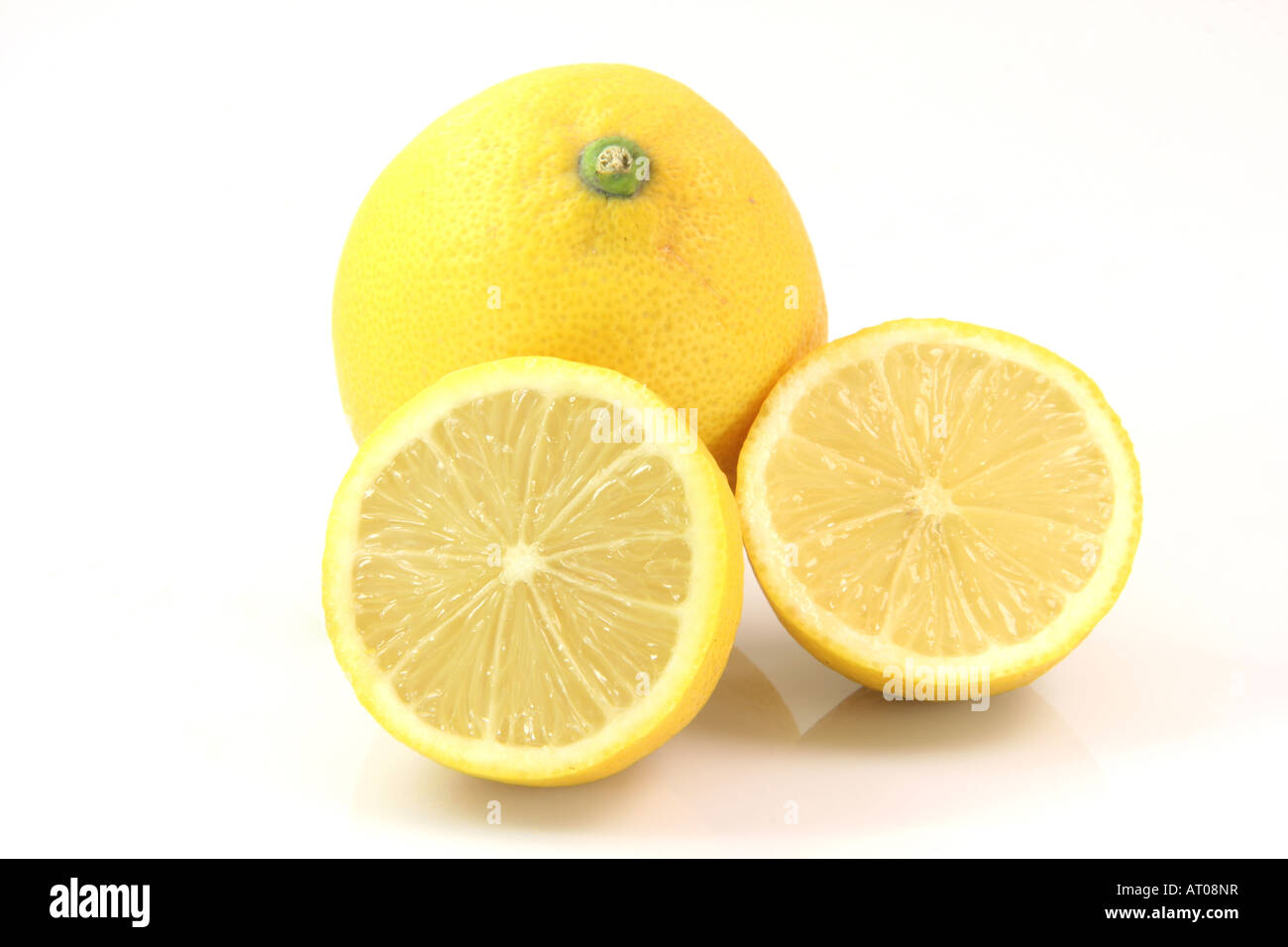 two lemons one cut in half isolated on white background fruits and ...