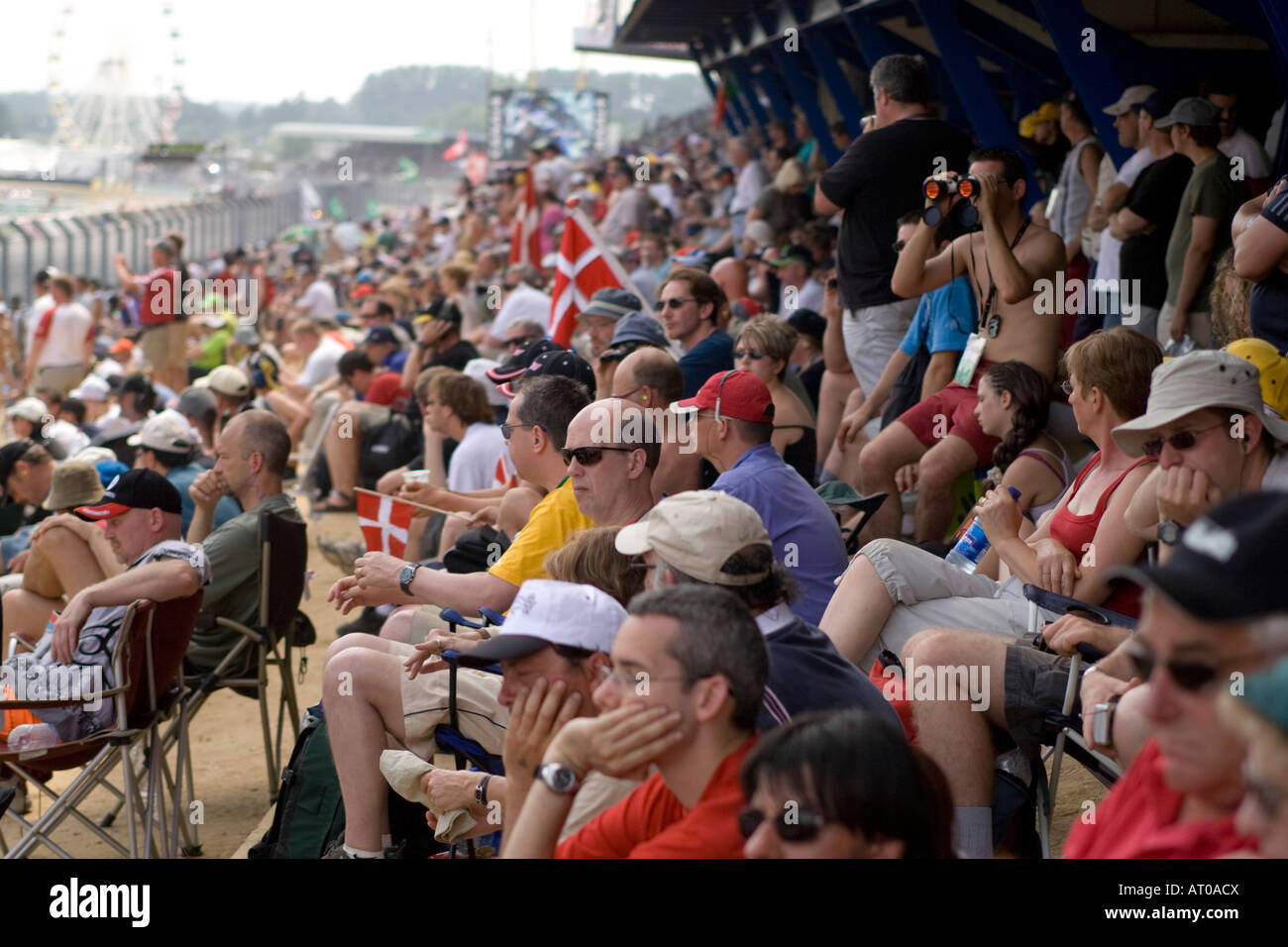 Crowds of spectators watch the Le Mans 24 hour race from the stands ...
