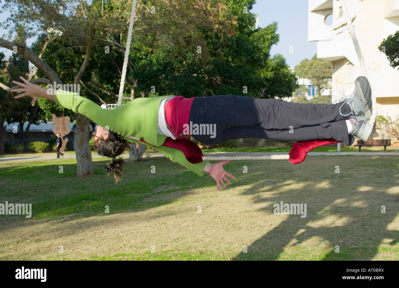 Female acrobat on a trapeze hands outstretched Stock Photo - Alamy