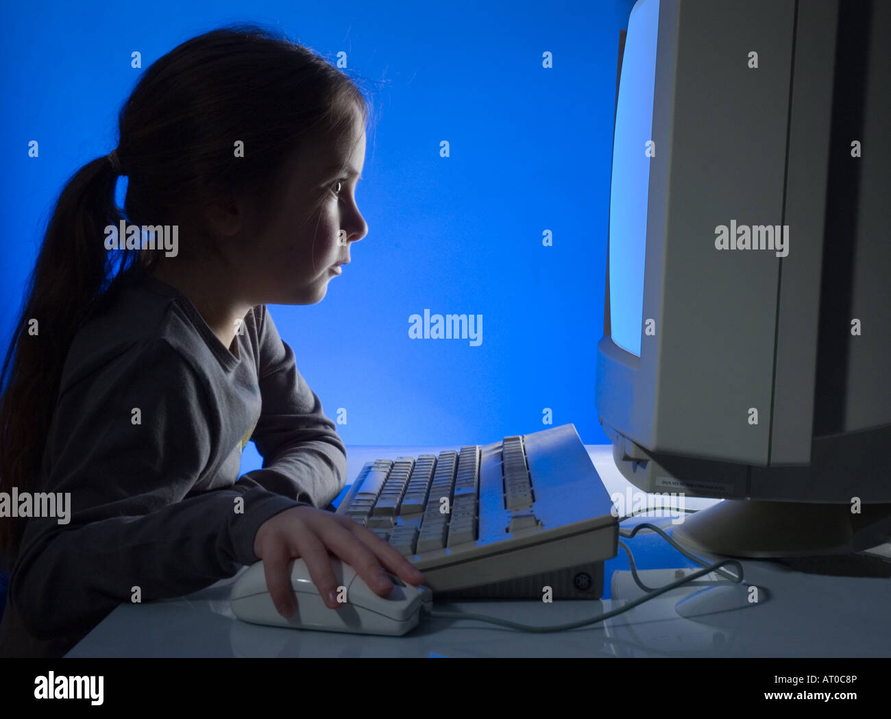 Little girl working at a computer Stock Photo - Alamy
