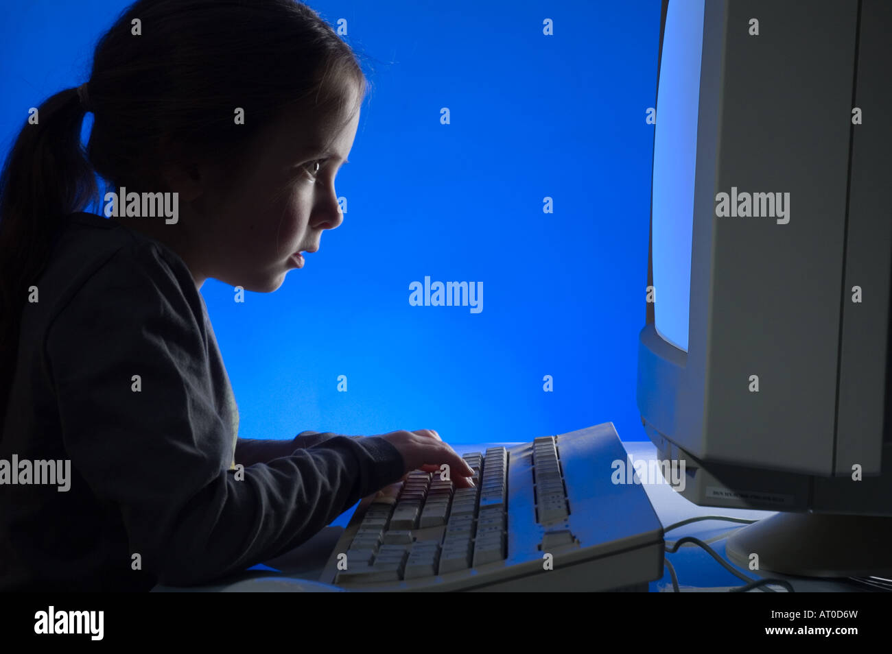 Little girl working at a computer Stock Photo - Alamy