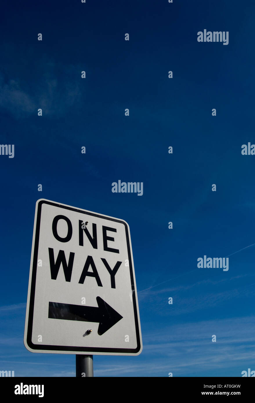 One way sign against a blue sky Stock Photo - Alamy