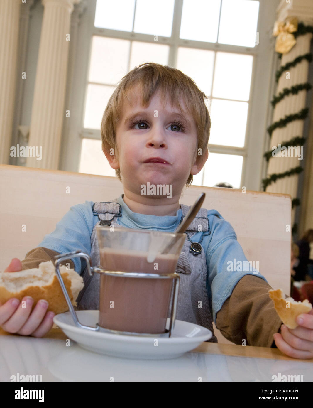 little boy having an afternoon snack and hot chocolate Stock Photo - Alamy