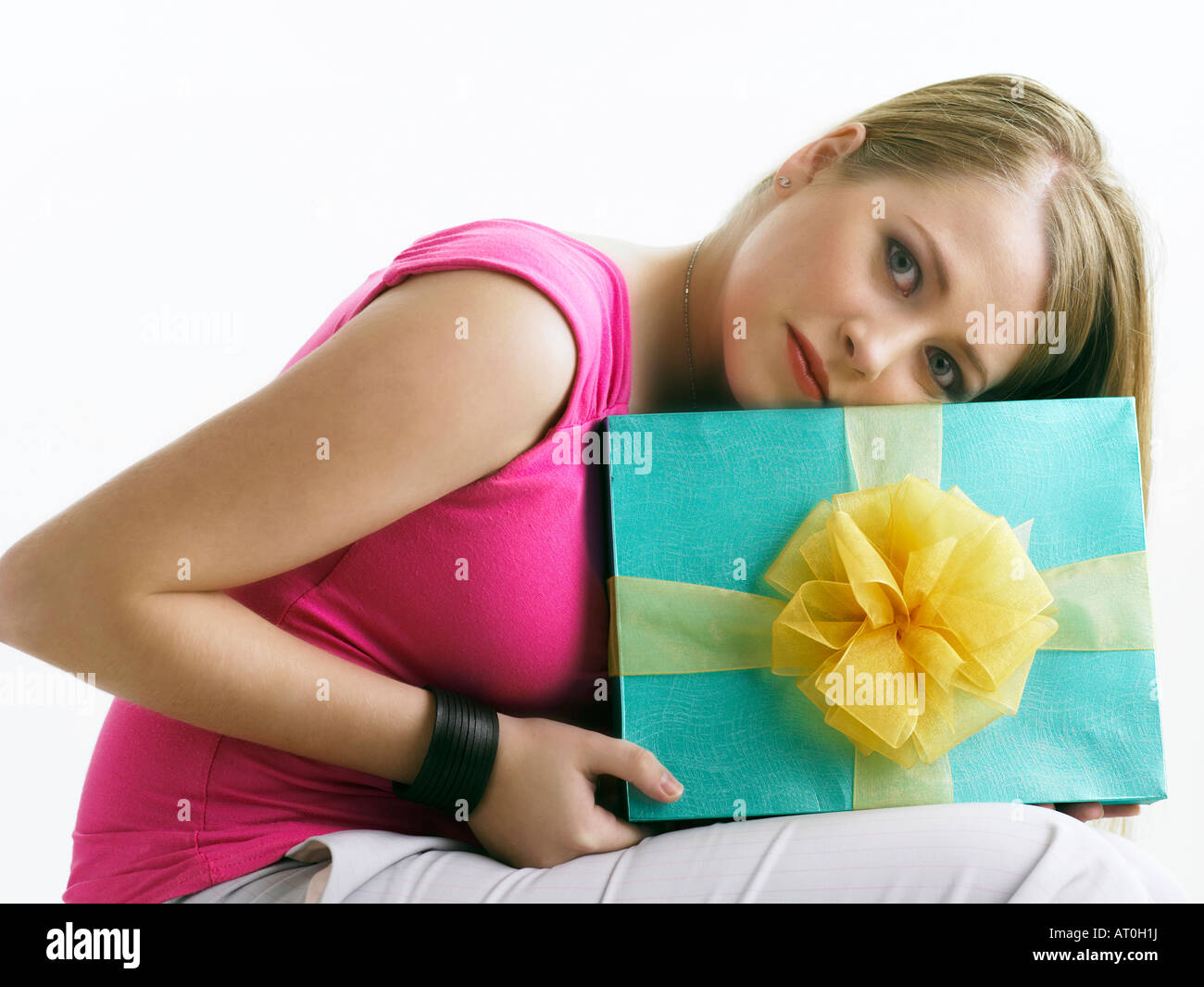 Woman posing to camera while showing off her present Stock Photo - Alamy