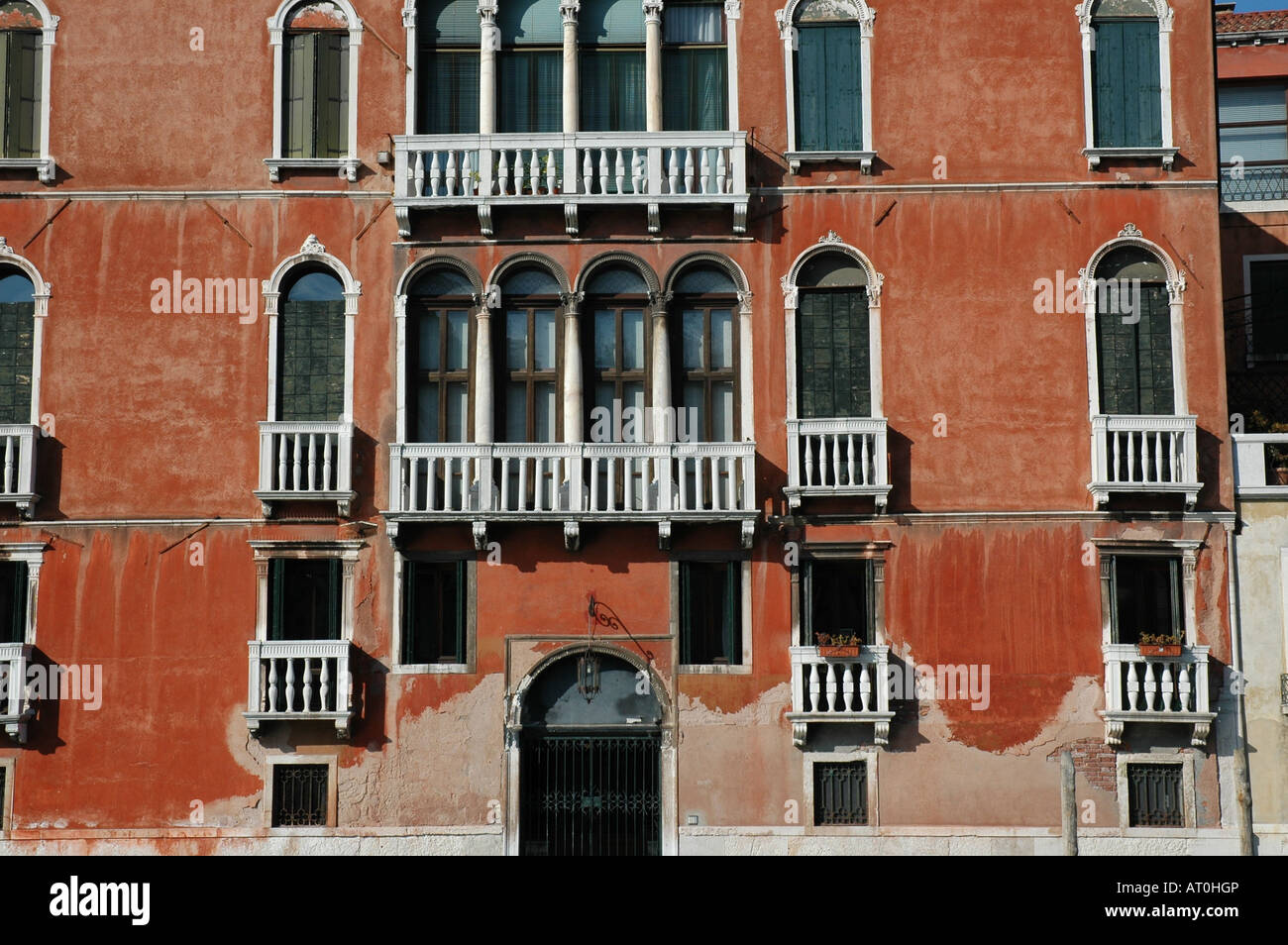 canalside building in venice with balconies and arched windows and ...