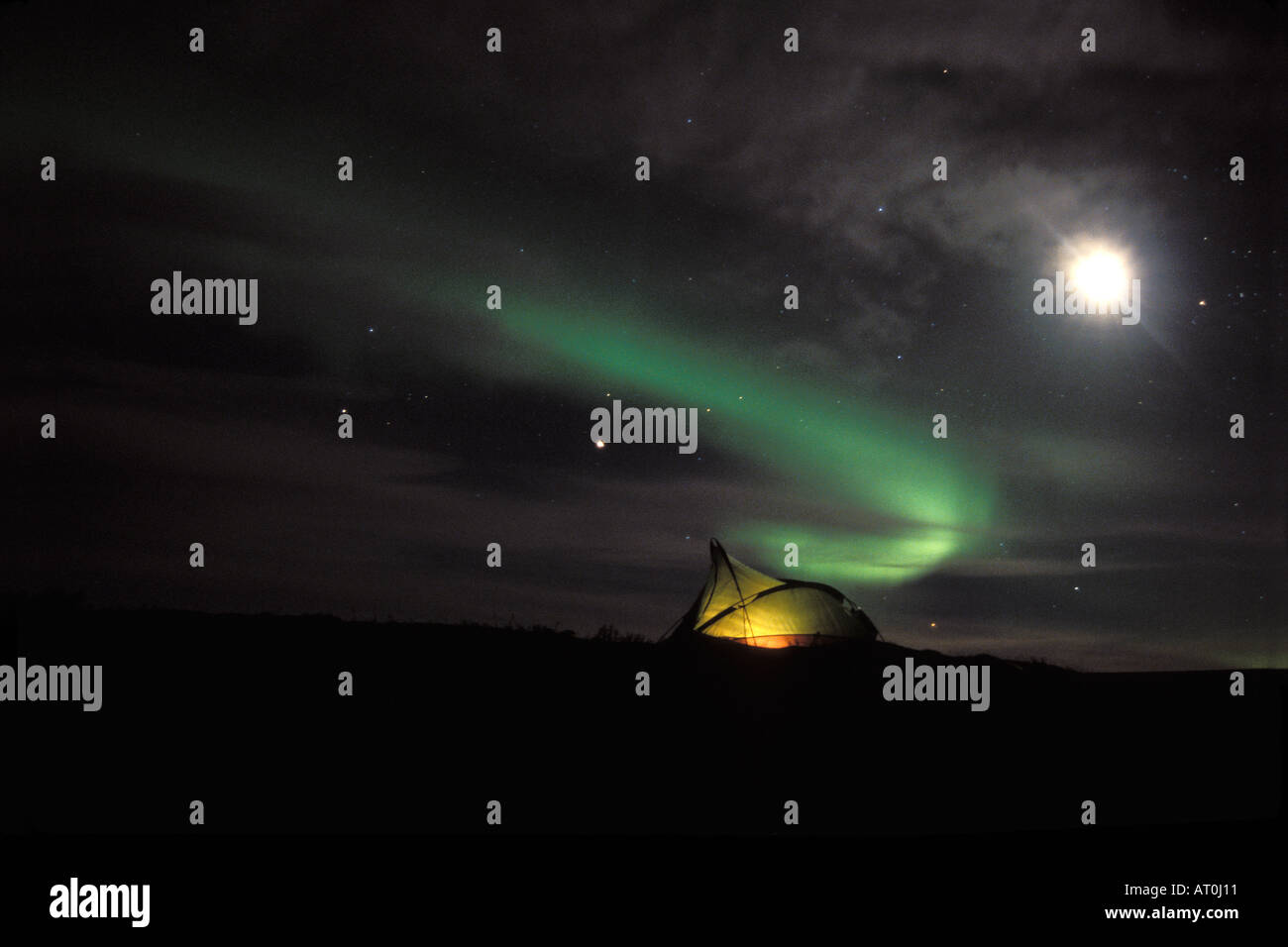 northern lights Aurora borealis and full moon over campsite on the ...