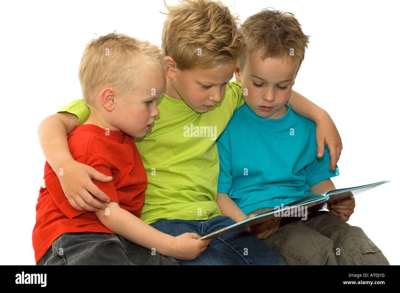 Three boys reading a book holding each other Stock Photo - Alamy