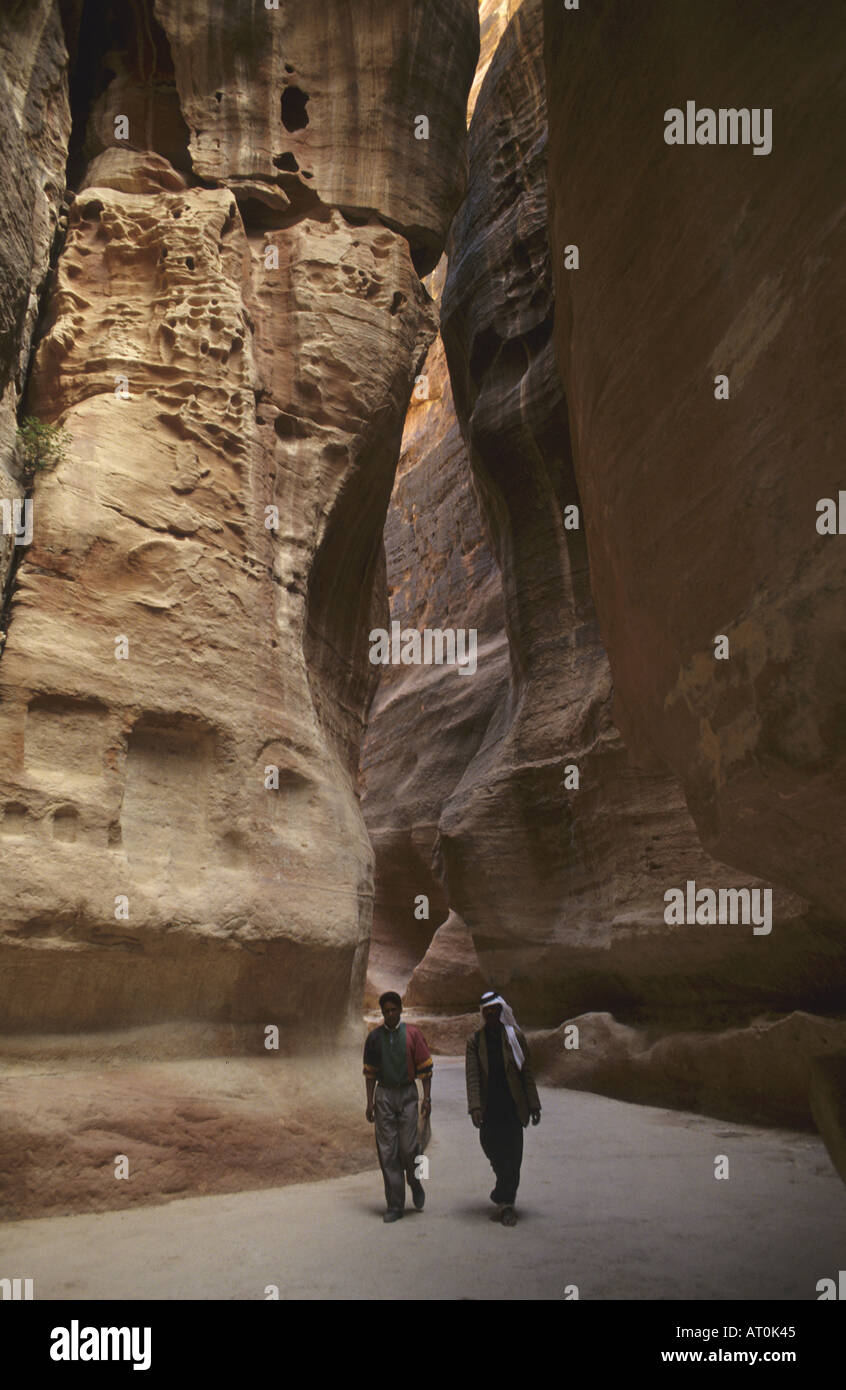 Bedouins walking inside Sik narrow gorge that leads Khazneh Sik canyon Gorge of Petra Jordan ...