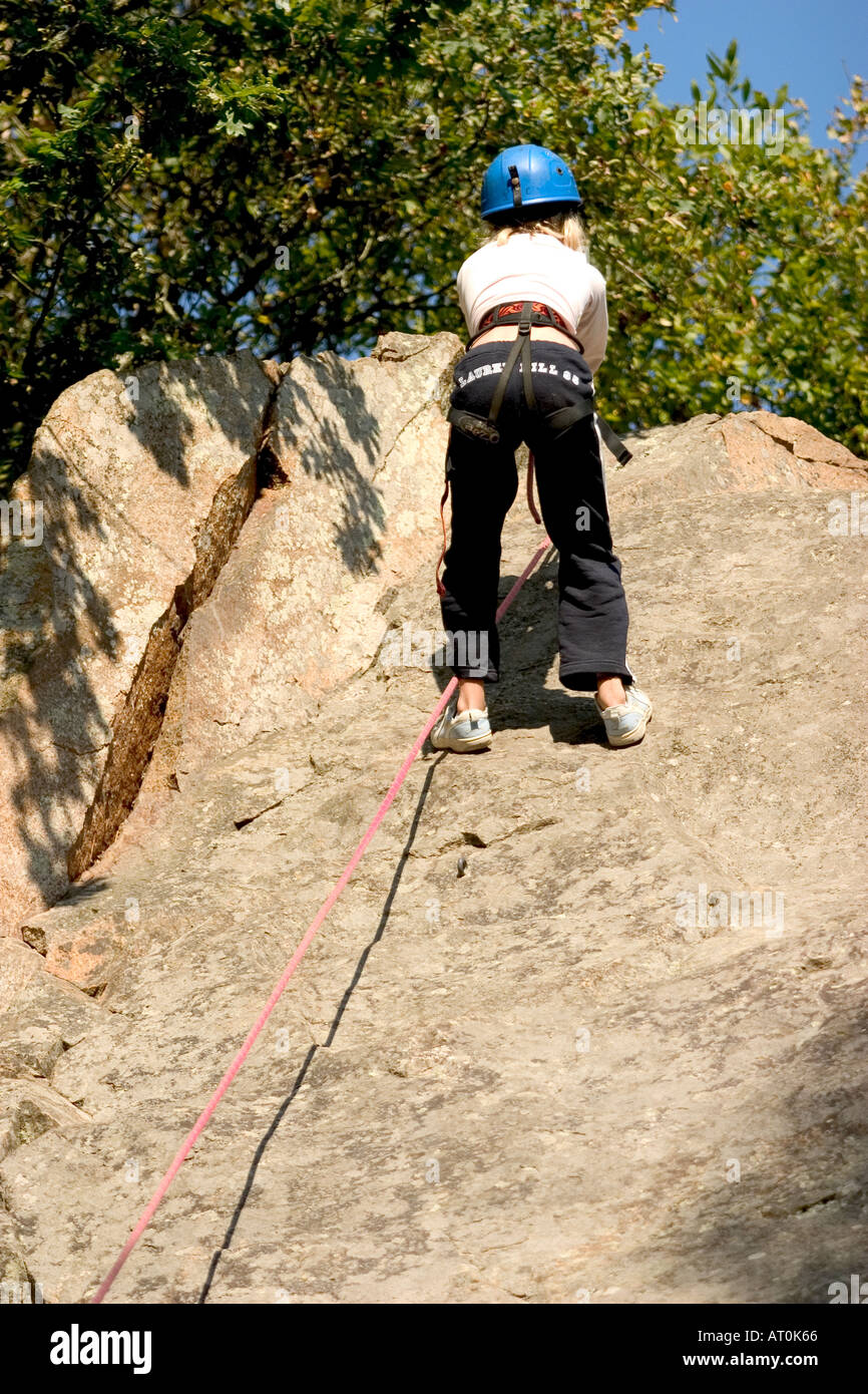 little girl female climbing a rock Stock Photo - Alamy
