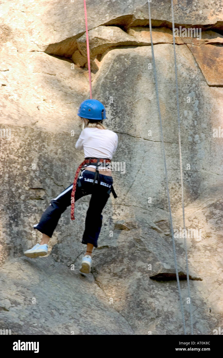 little girl female climbing a rock Stock Photo - Alamy
